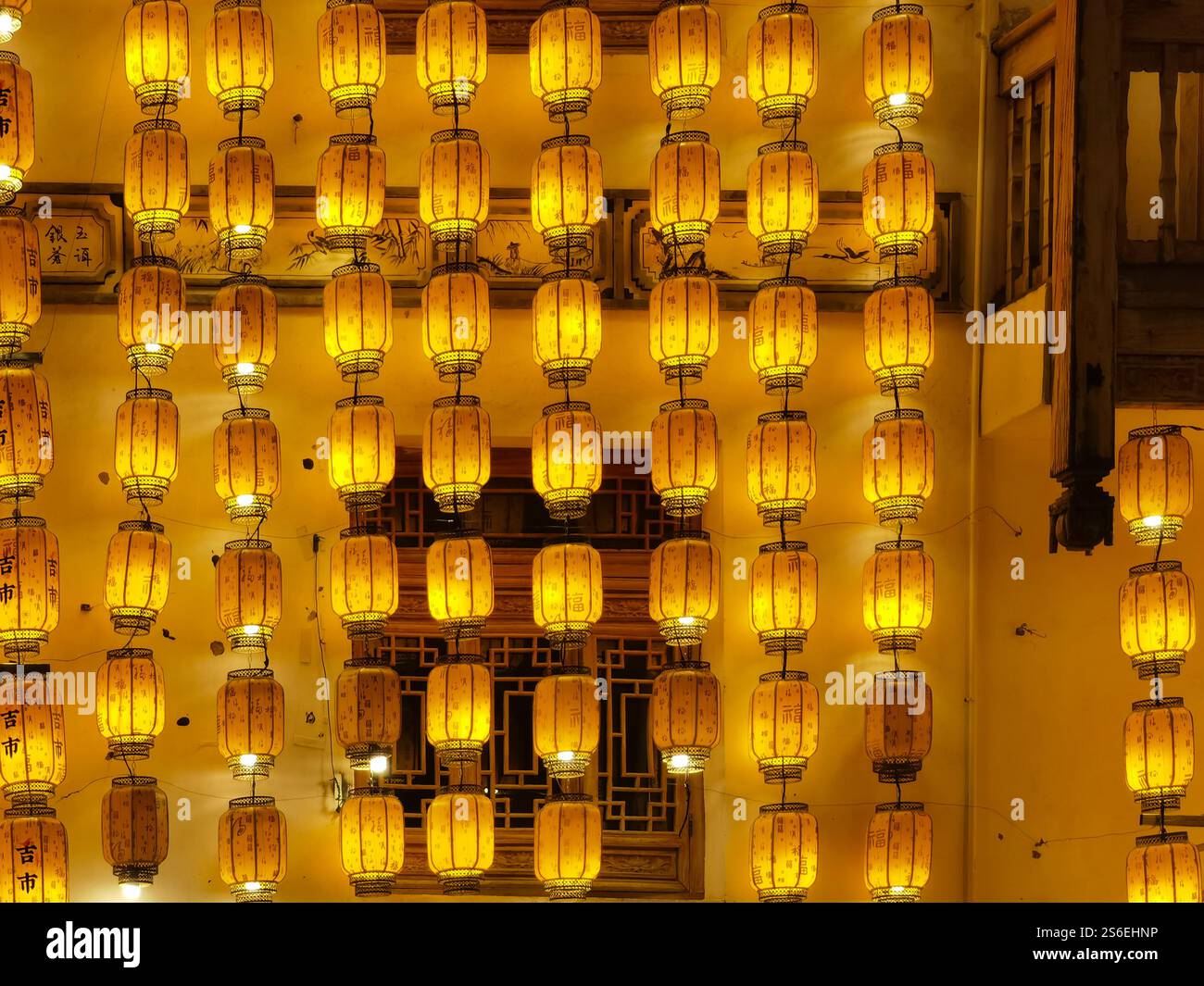 Dali, China - November 19, 2024 : Illuminated amber lanterns hang in ...