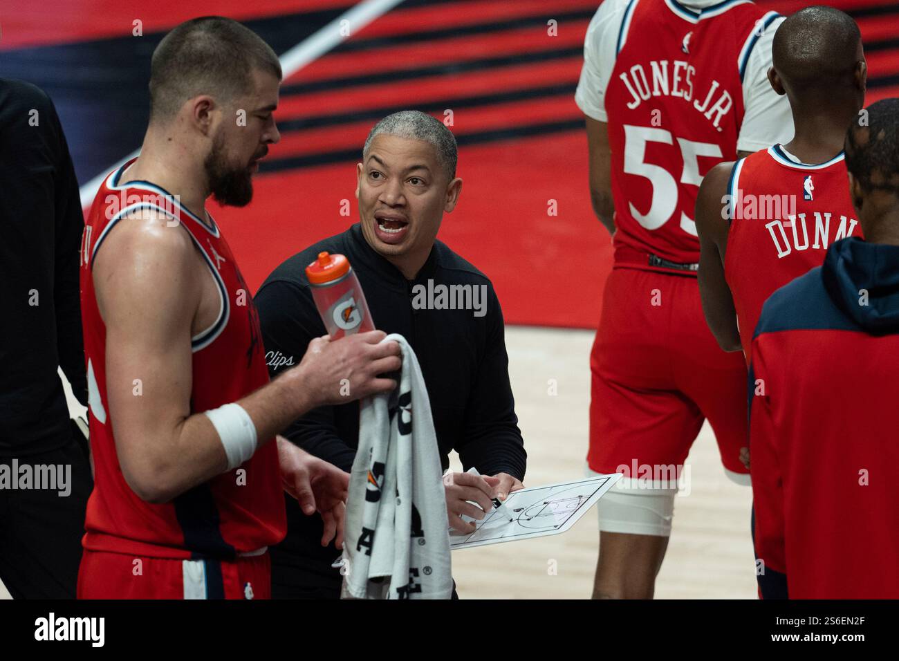 Los Angeles Clippers head coach Tyronn Lue, second from left, talks ...