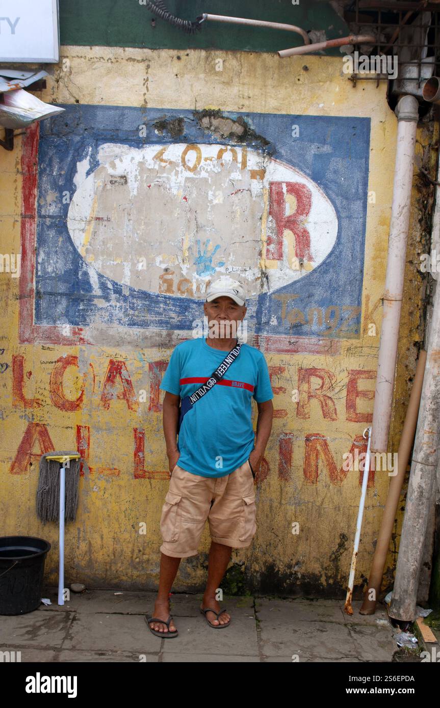 Old man stood next to a Load Here sign, Cadiz City, Negros Occidental ...