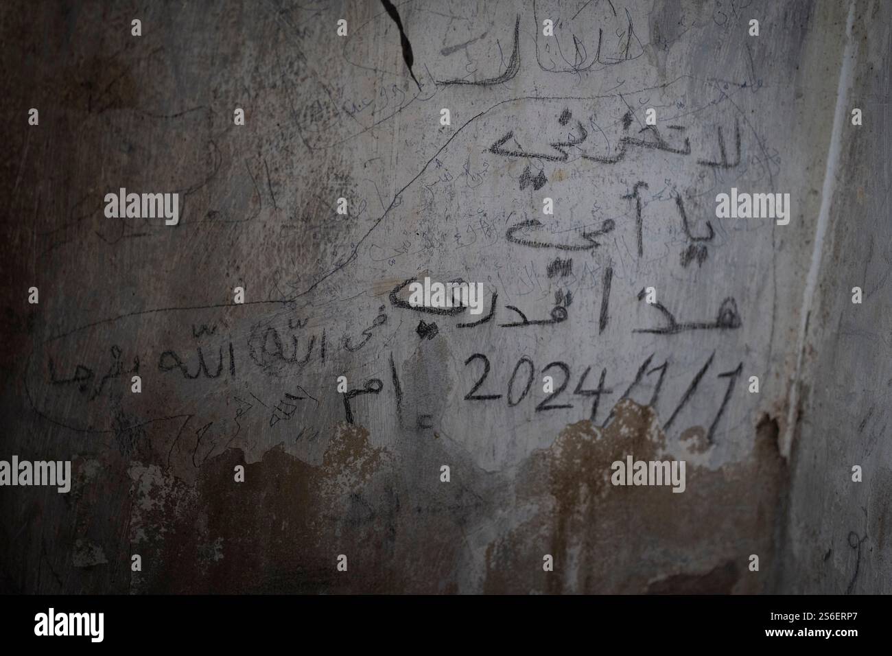 A graffiti in Arabic on the wall of a prison cell reads "Don't be sad ...