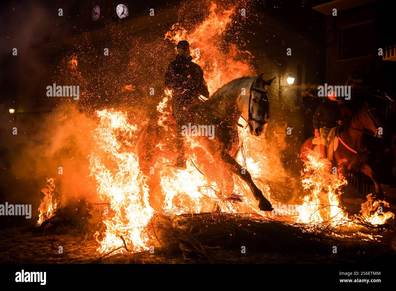 A horseman jumps over a bonfire in the village of San Bartolome de ...