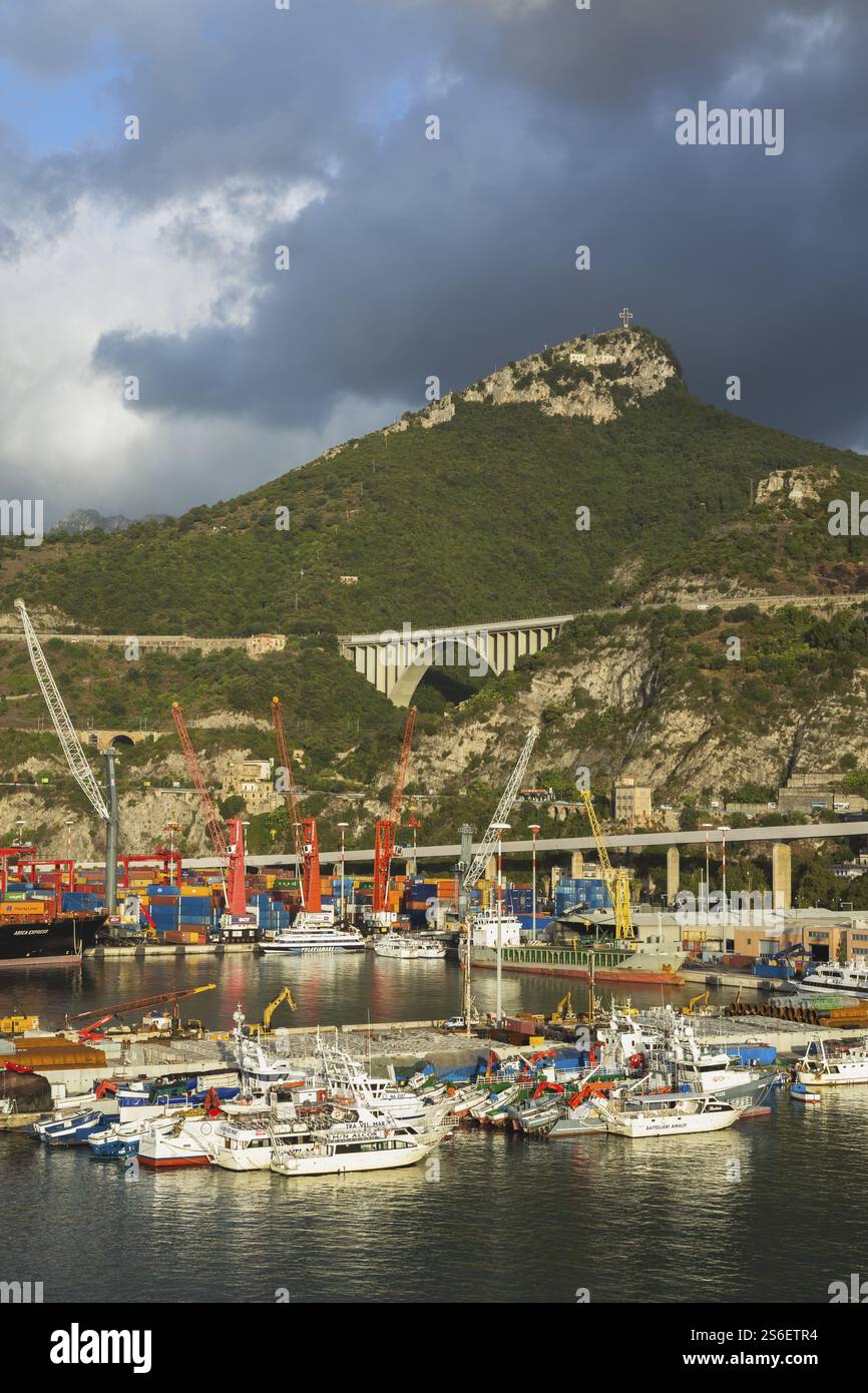 Docked commercial boats plus stacked shipping containers and loading ...