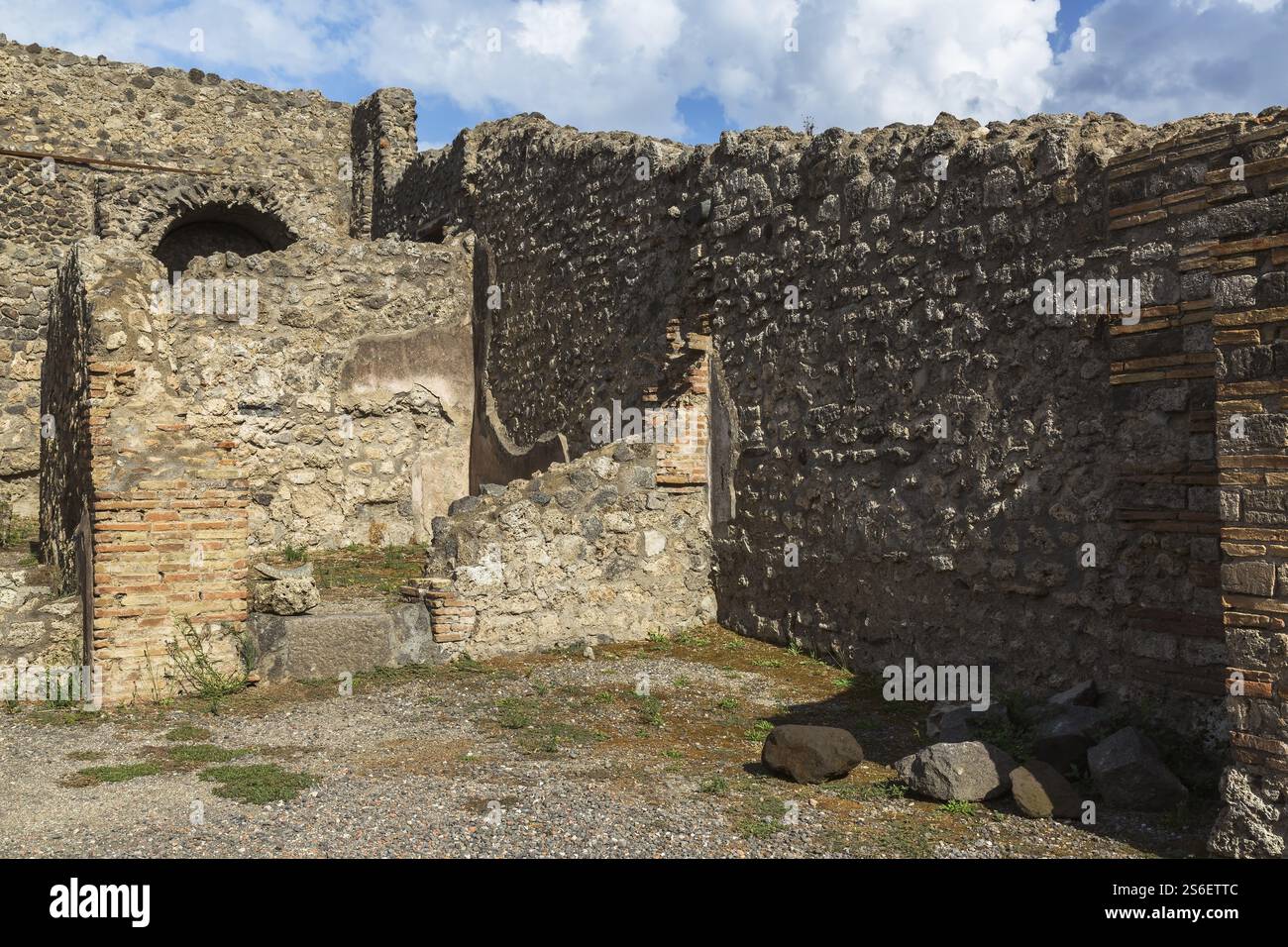 Remnants of old terracotta brick and stone wall structures with arched ...