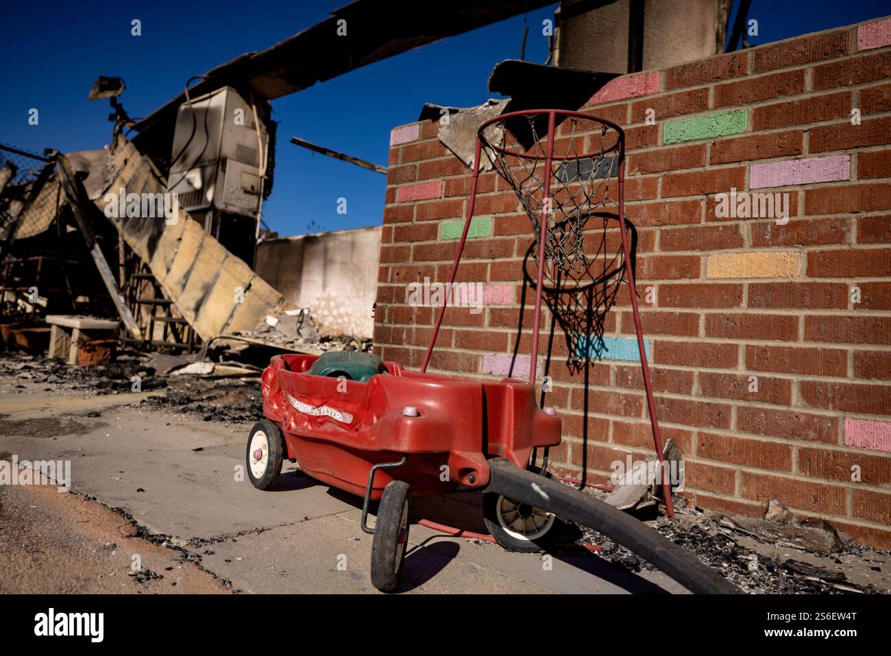A melted Radio Flyer wagon sits outside the burned down Marquez School ...