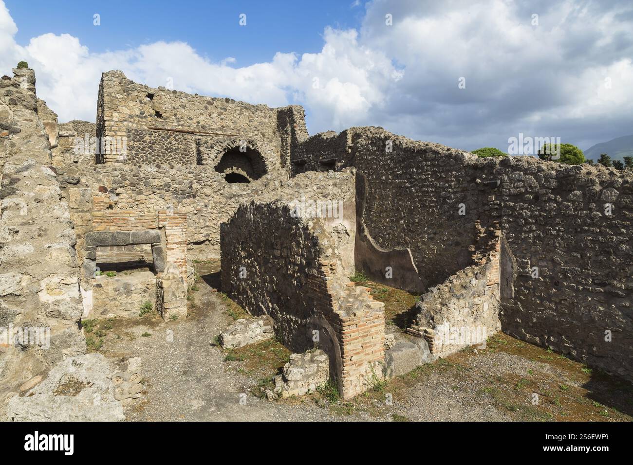 Remnants of old terracotta brick and stone wall structures with ...