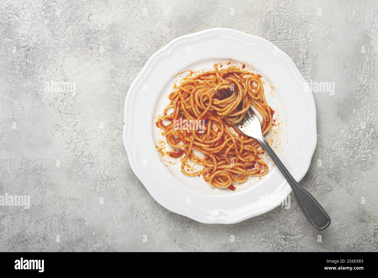 A plate with leftover spaghetti bolognese, no people Stock Photo - Alamy