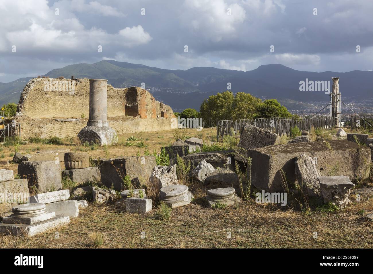 Old broken pieces of marble columns and slabs of carved stone plus ...