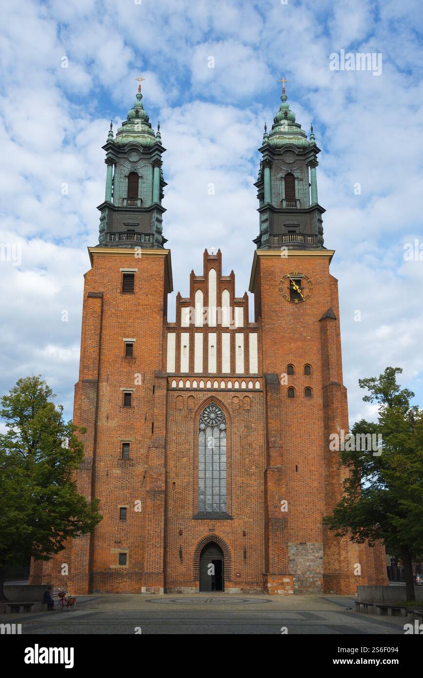 Gothic brick cathedral with imposing towers against a blue sky ...