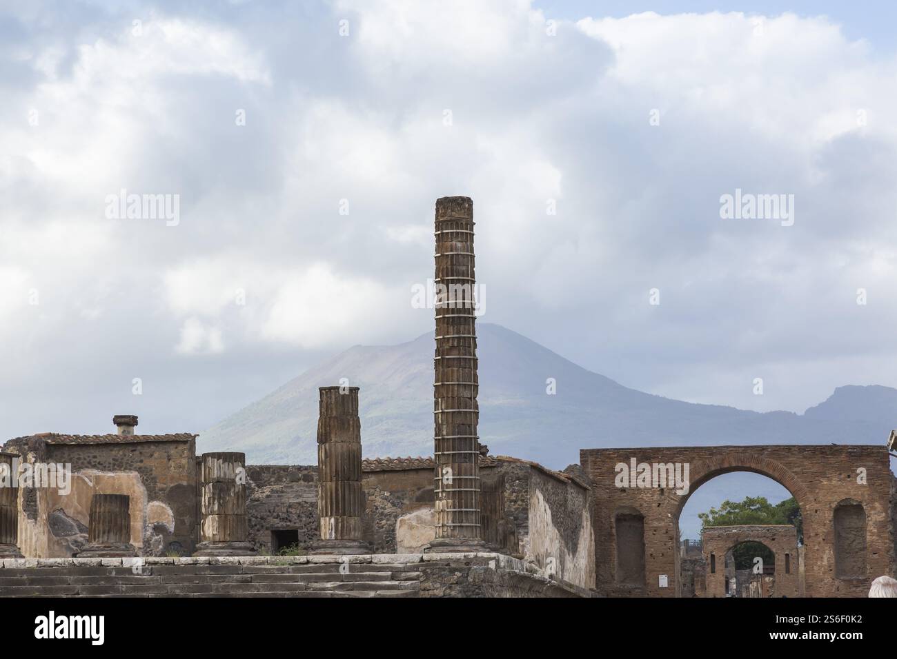 Old stone columns supported by braces and terracotta brick wall ...