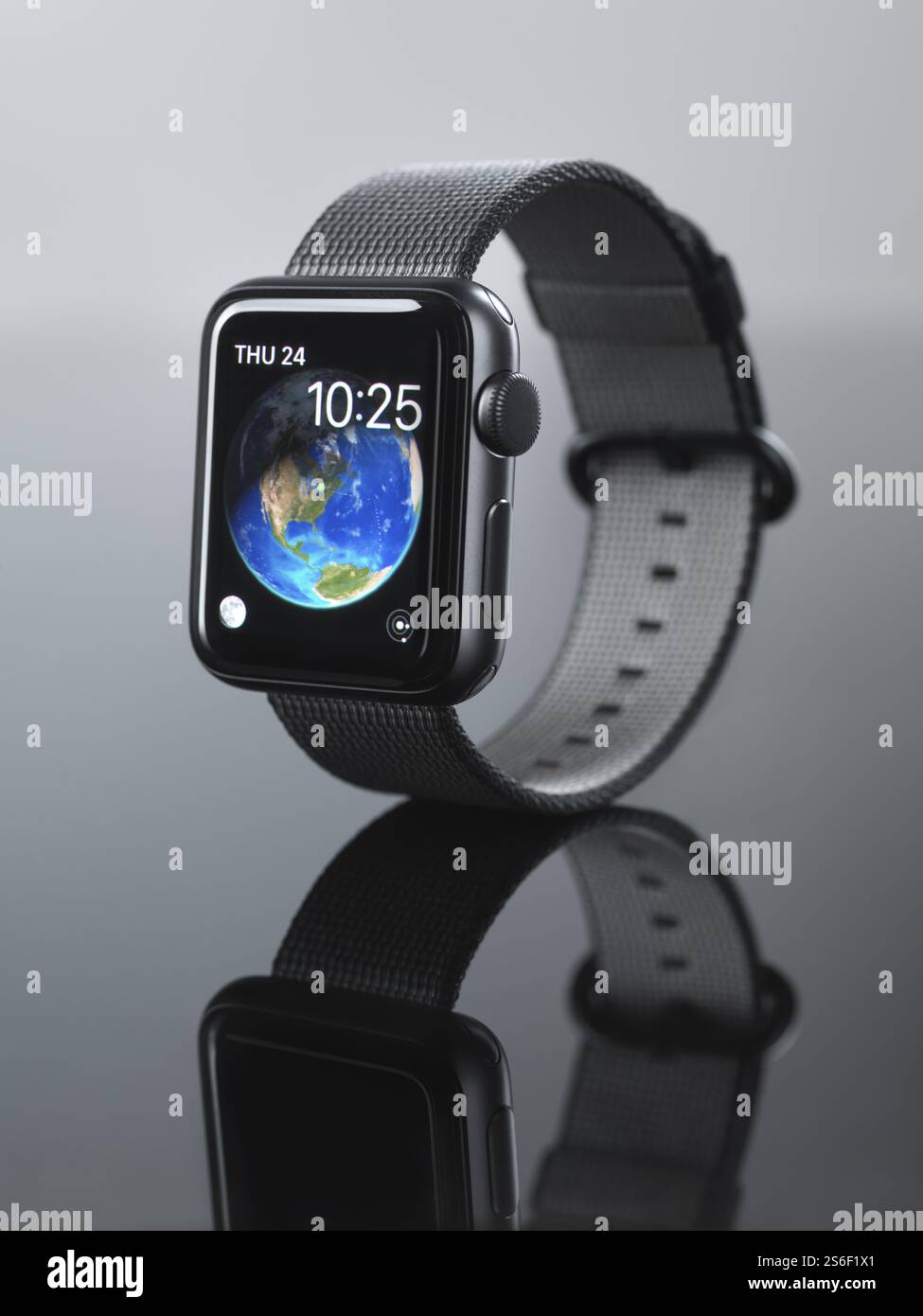 Shiny steel Apple Watch series 2 smartwatch with clock displaying Earth ...