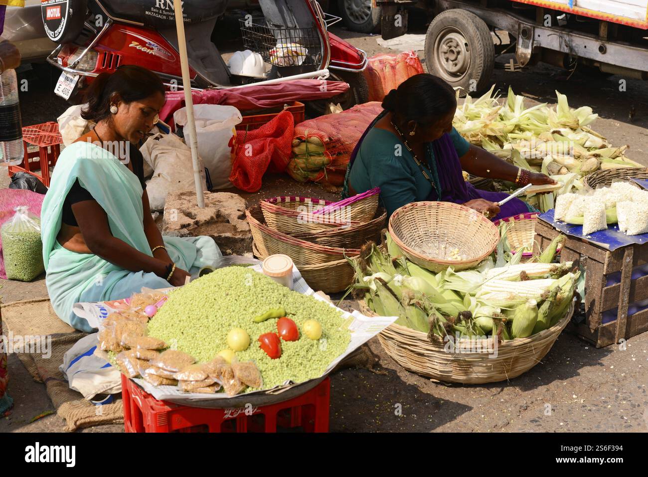 Two woman selling vegetables at a roadside market stall, Aurangabad ...
