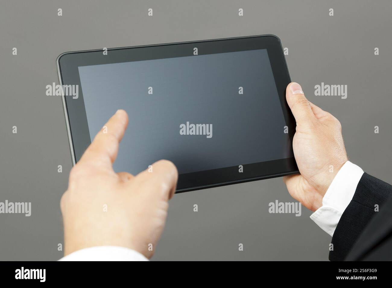 An image of a handsome business man pointing to his tablet pc Stock ...