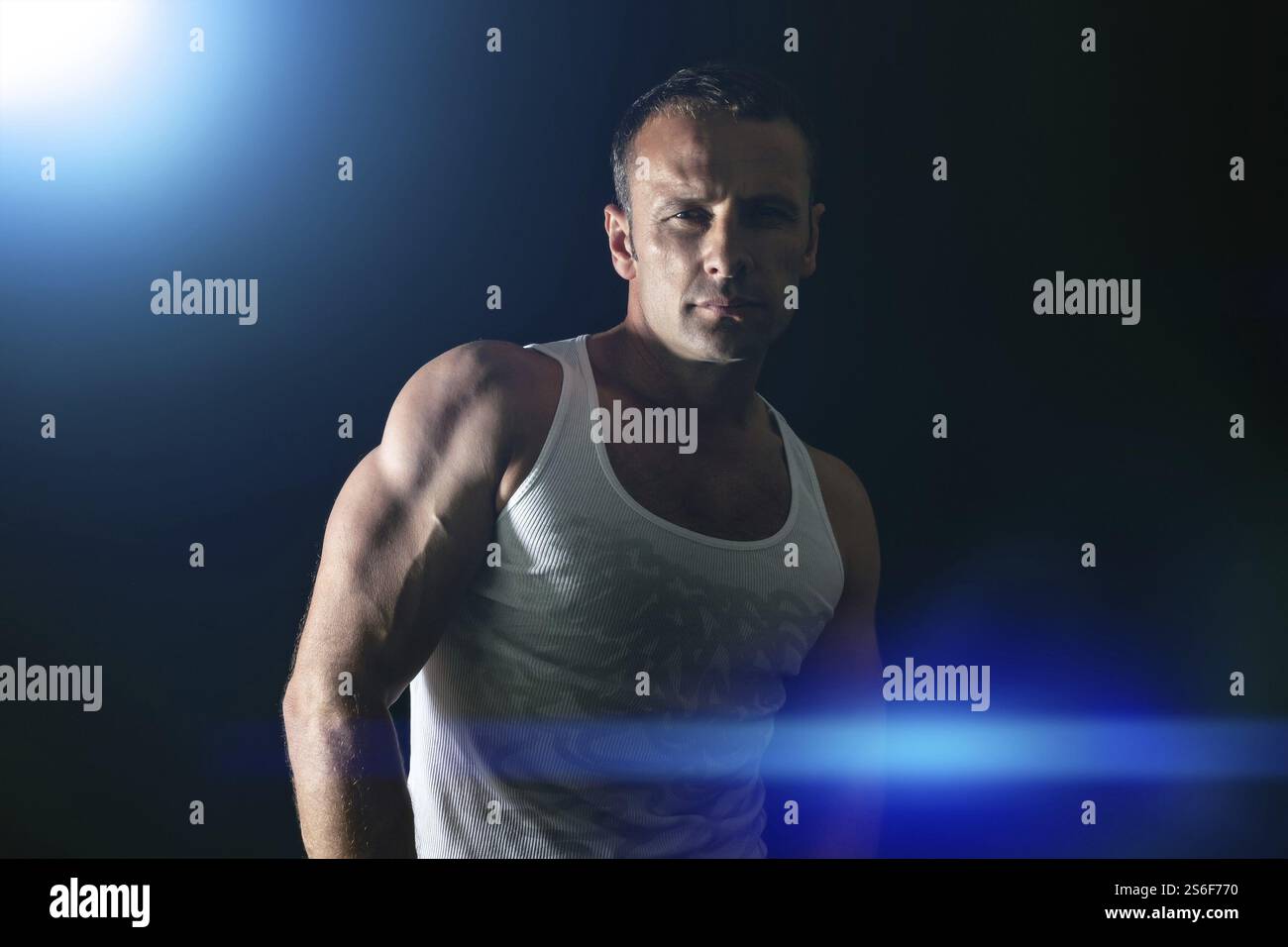 An image of a handsome muscle man blue light Stock Photo - Alamy