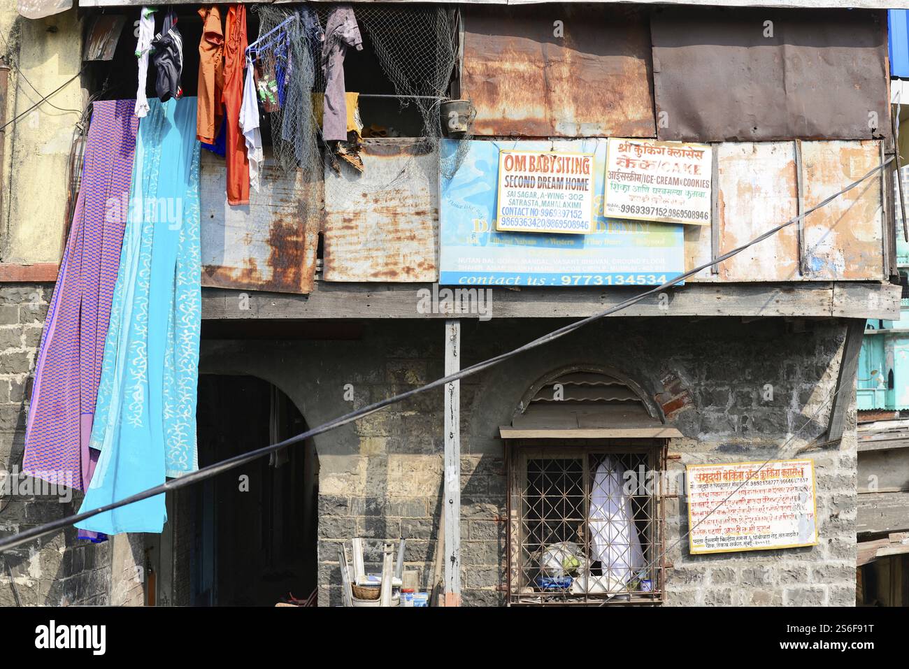 Older building with coloured laundry and informal signs on the facade ...