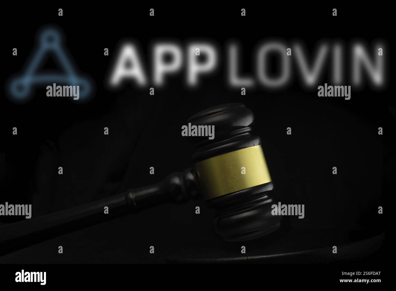 Court gavel in front of the App lovin logo. AppLovin Corporation is an ...