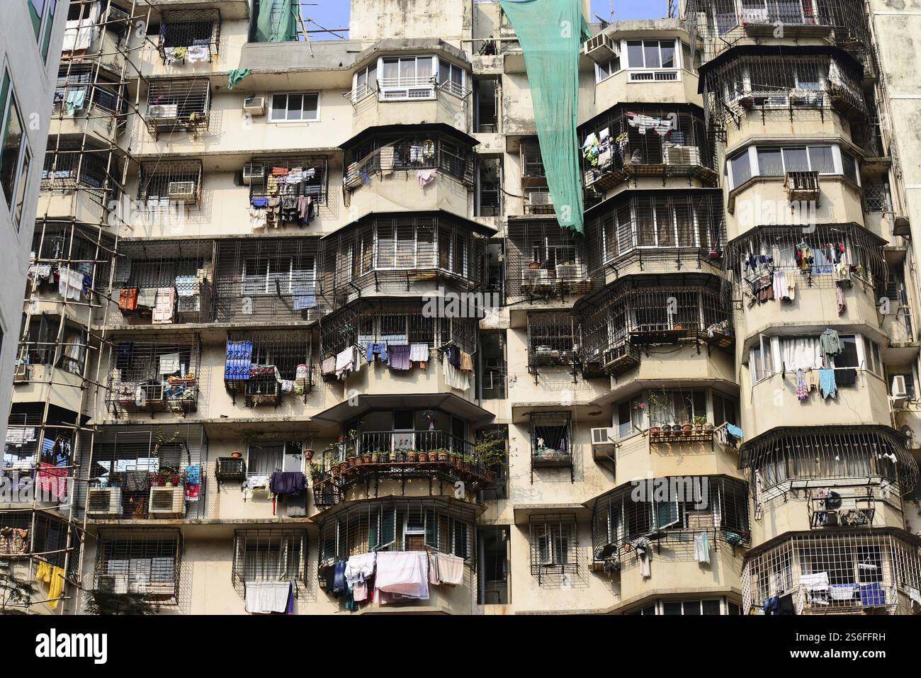 High-rise building with numerous rounded balconies and hanging laundry ...