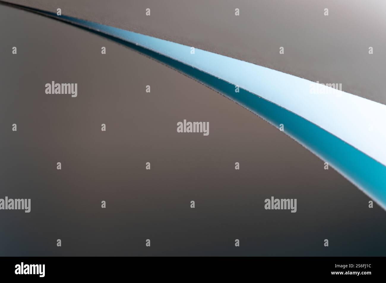 Curved shapes in vibrant blue tints blend together harmoniously ...