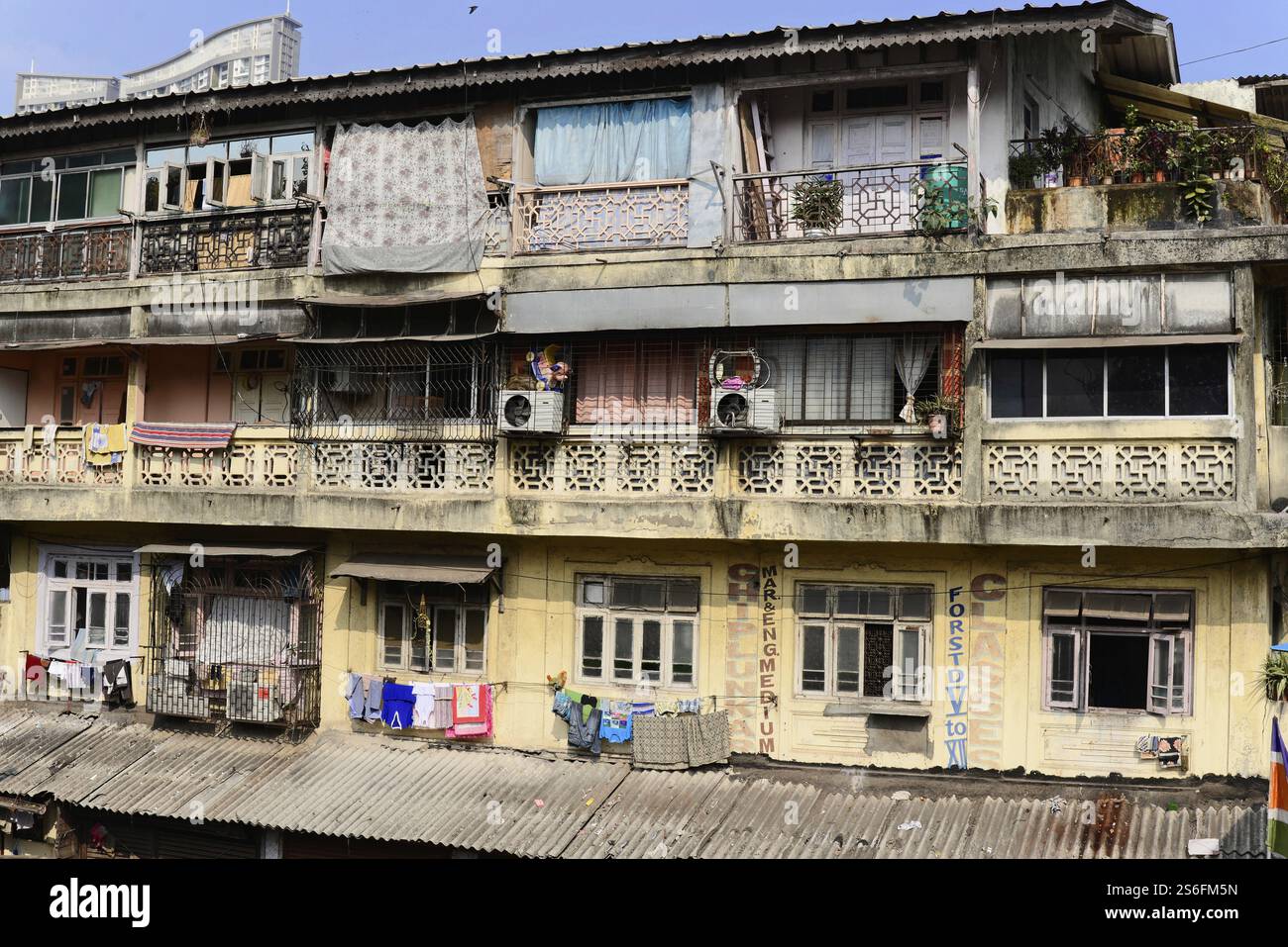 Old apartment building with hanging laundry on balconies in a city ...