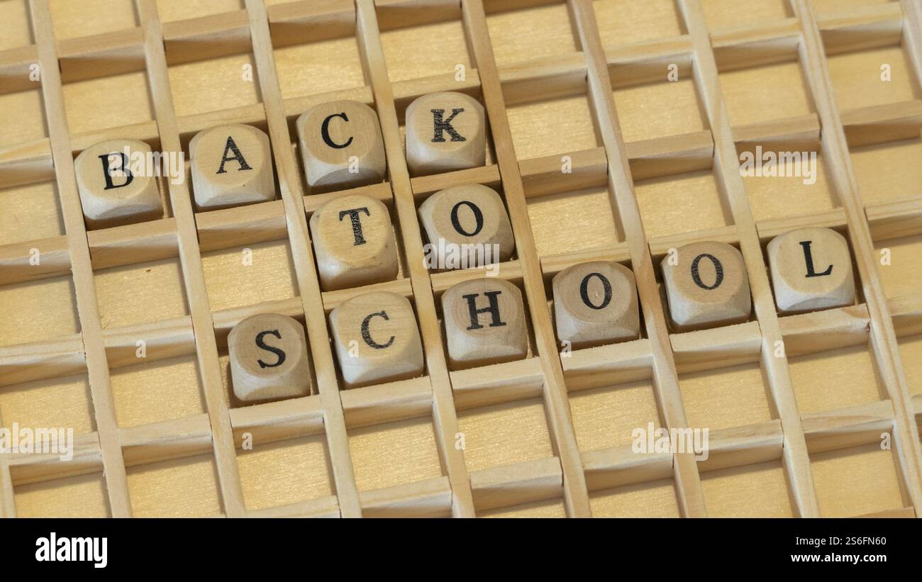 An image of wooden dice text back to school Stock Photo - Alamy
