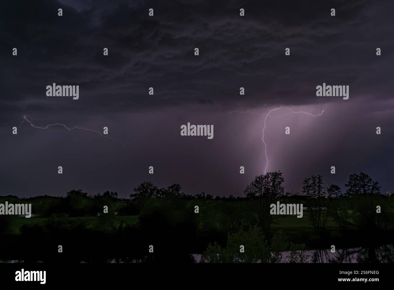 Dramatic beam of lightning illuminates the night sky during a ...