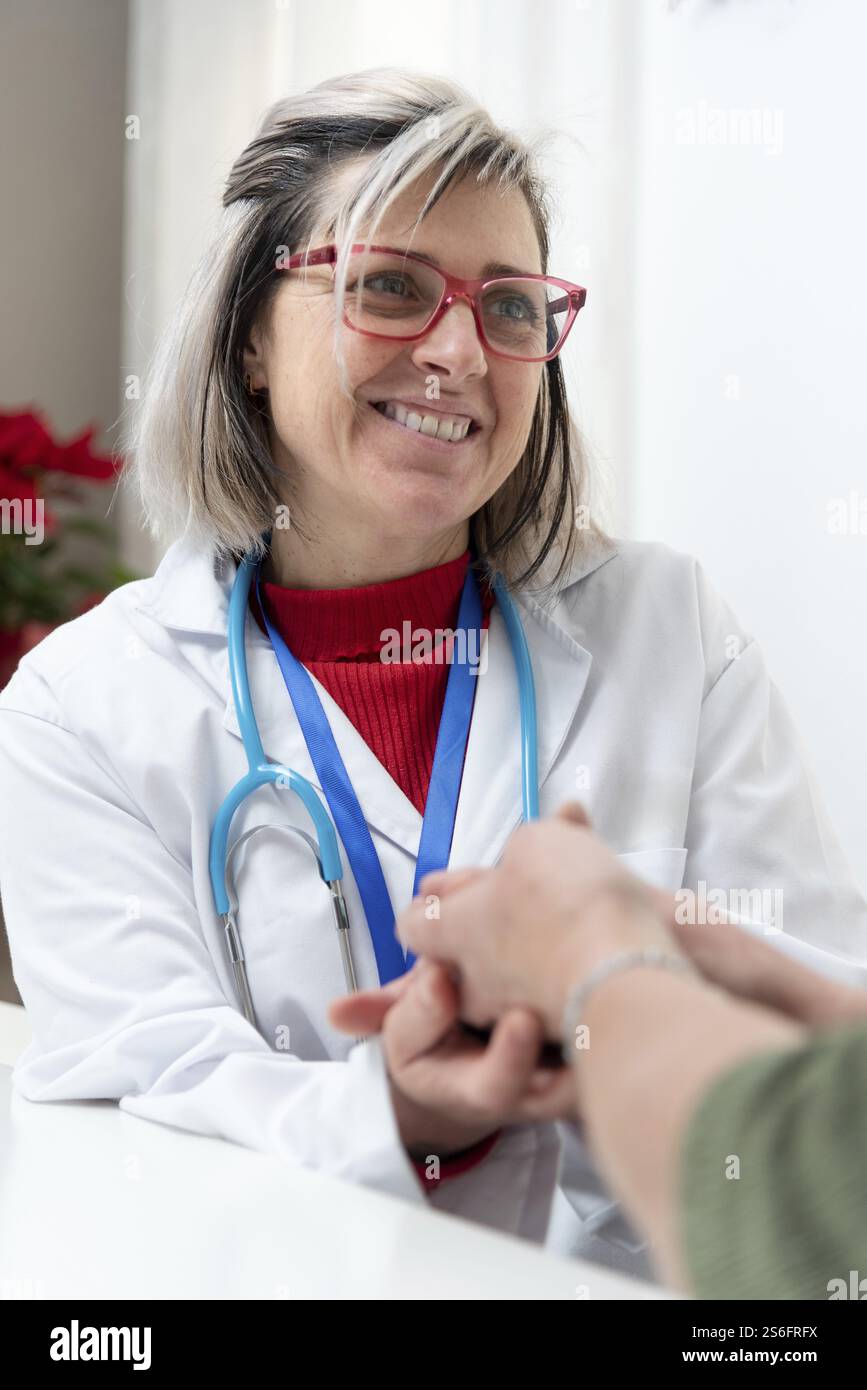 Female doctor providing comfort and support to patient during a home ...