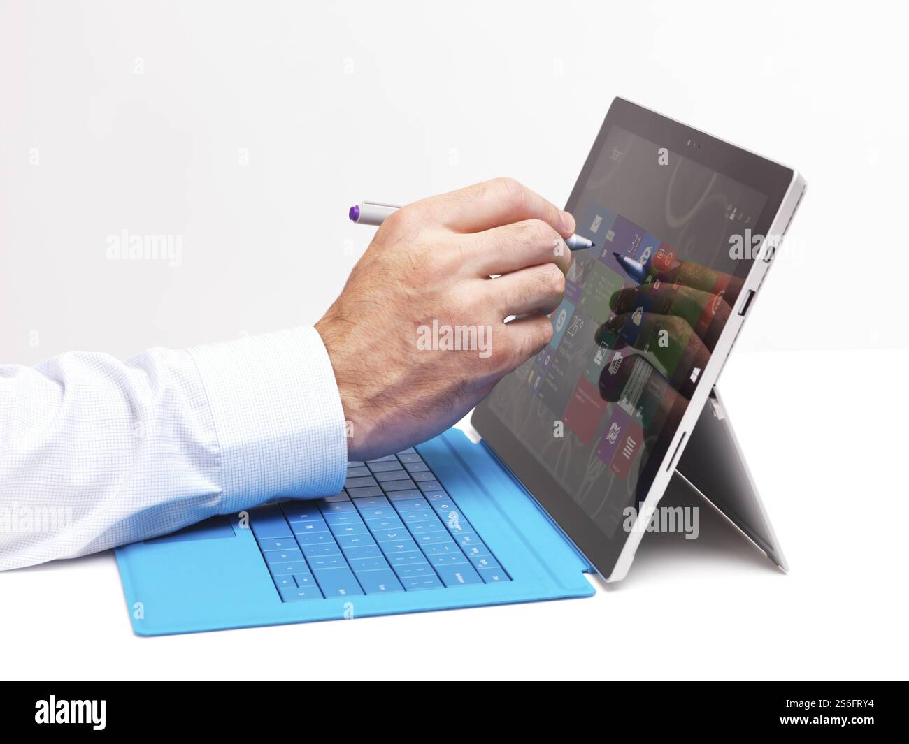 Person's hand with a pen touching display of Microsoft Surface Pro 3 ...