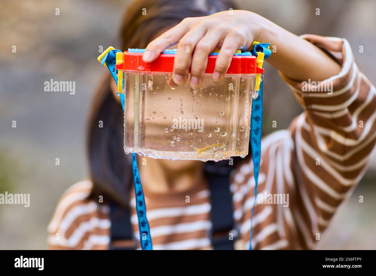 Happy girl taking a look at the fish she caught Stock Photo - Alamy