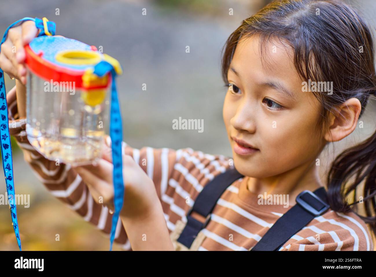 Happy girl taking a look at the fish she caught Stock Photo - Alamy