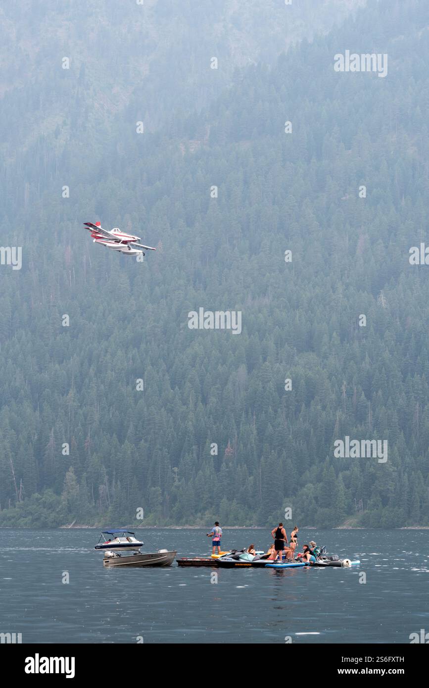 Aerial fire fighting plane descending to scoop water from Wallowa Lake ...