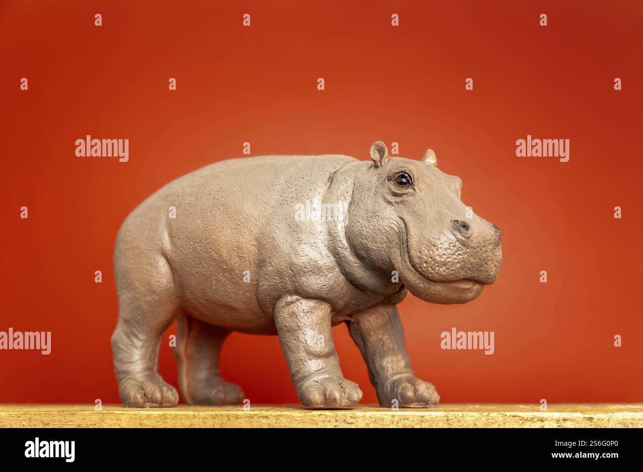 An image of a hippopotamus figure isolated on red background Stock ...