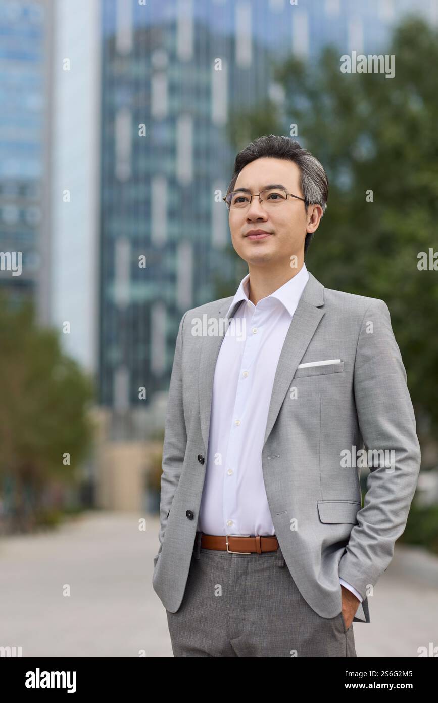 Mature businessman looking afar Stock Photo - Alamy
