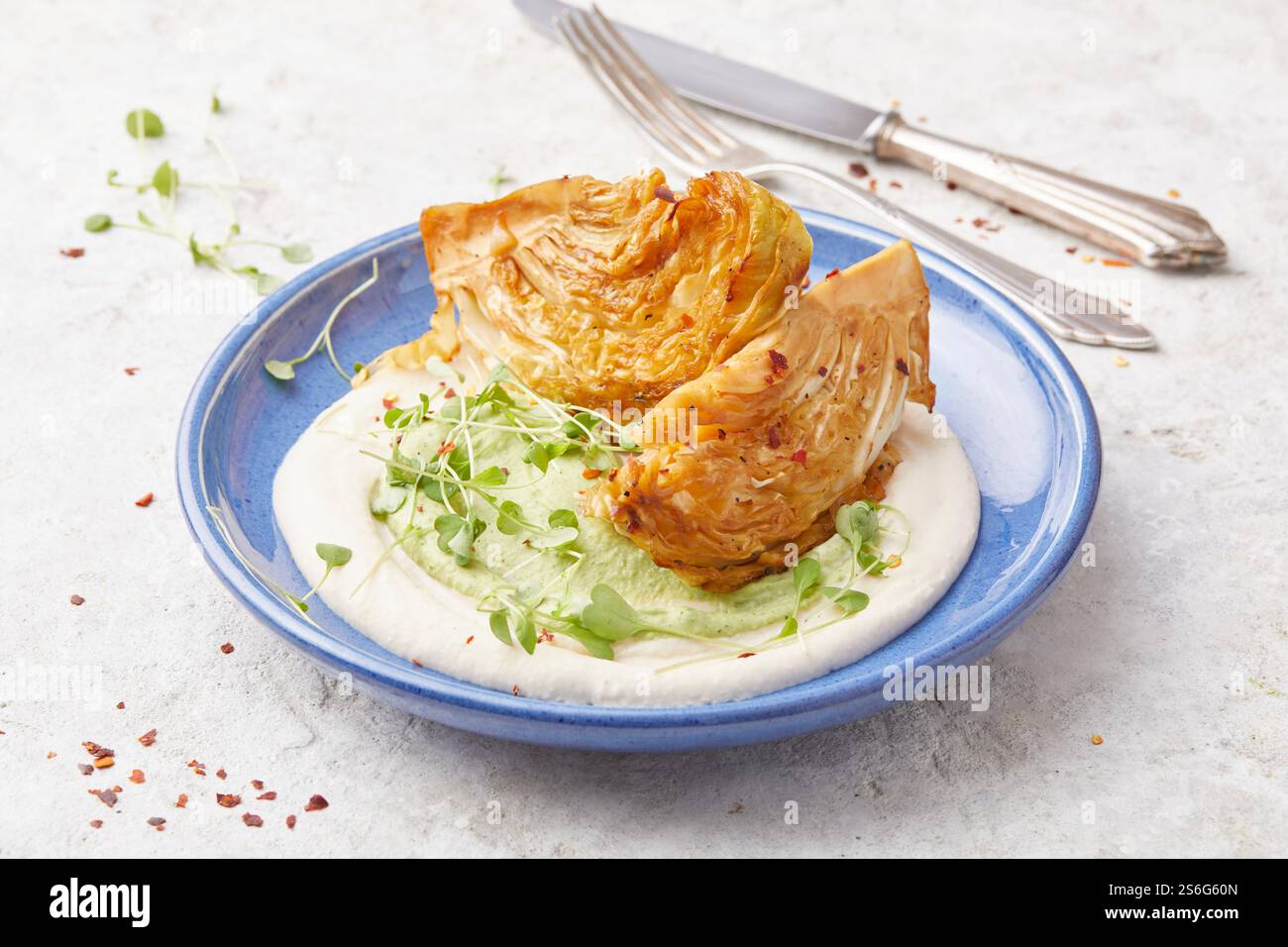 Baked Cabbage with Bean and Coriander Puree Stock Photo - Alamy