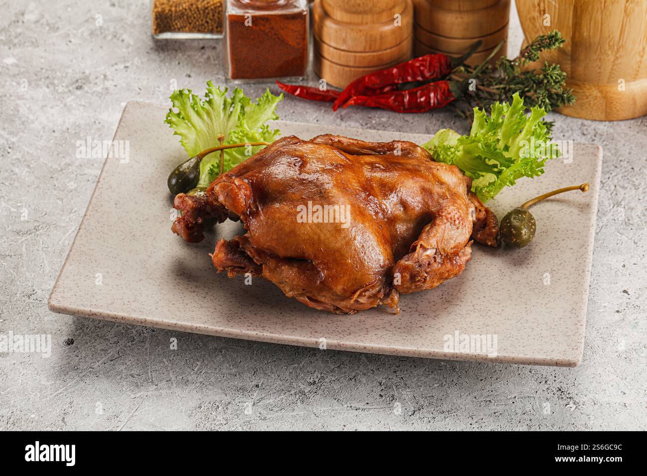 Baked whole small chicken with spices Stock Photo - Alamy