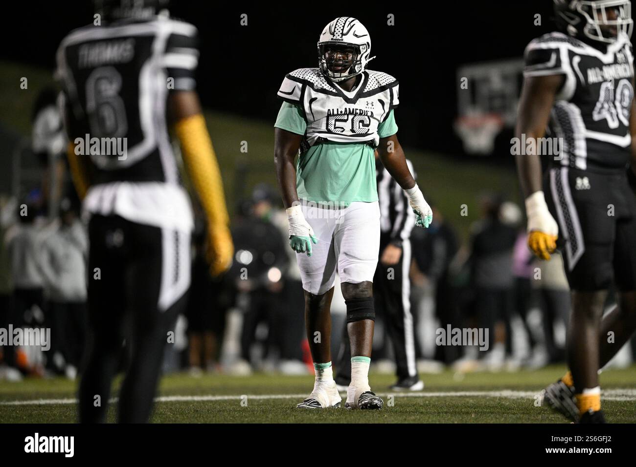 Team Unstoppable offensive lineman Michael Fasusi (56) sets up for a ...