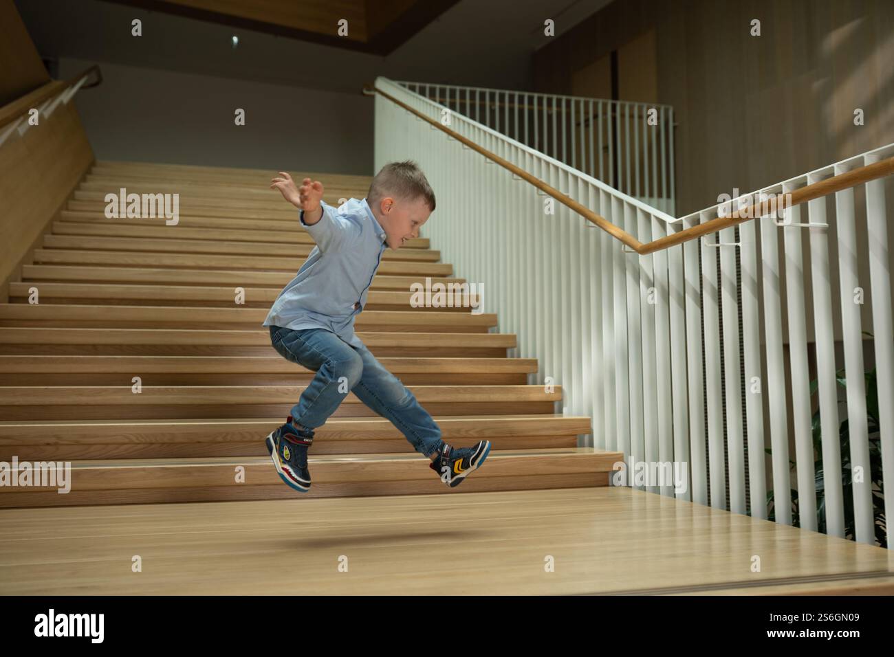Happy children jump in building stairs Stock Photo - Alamy