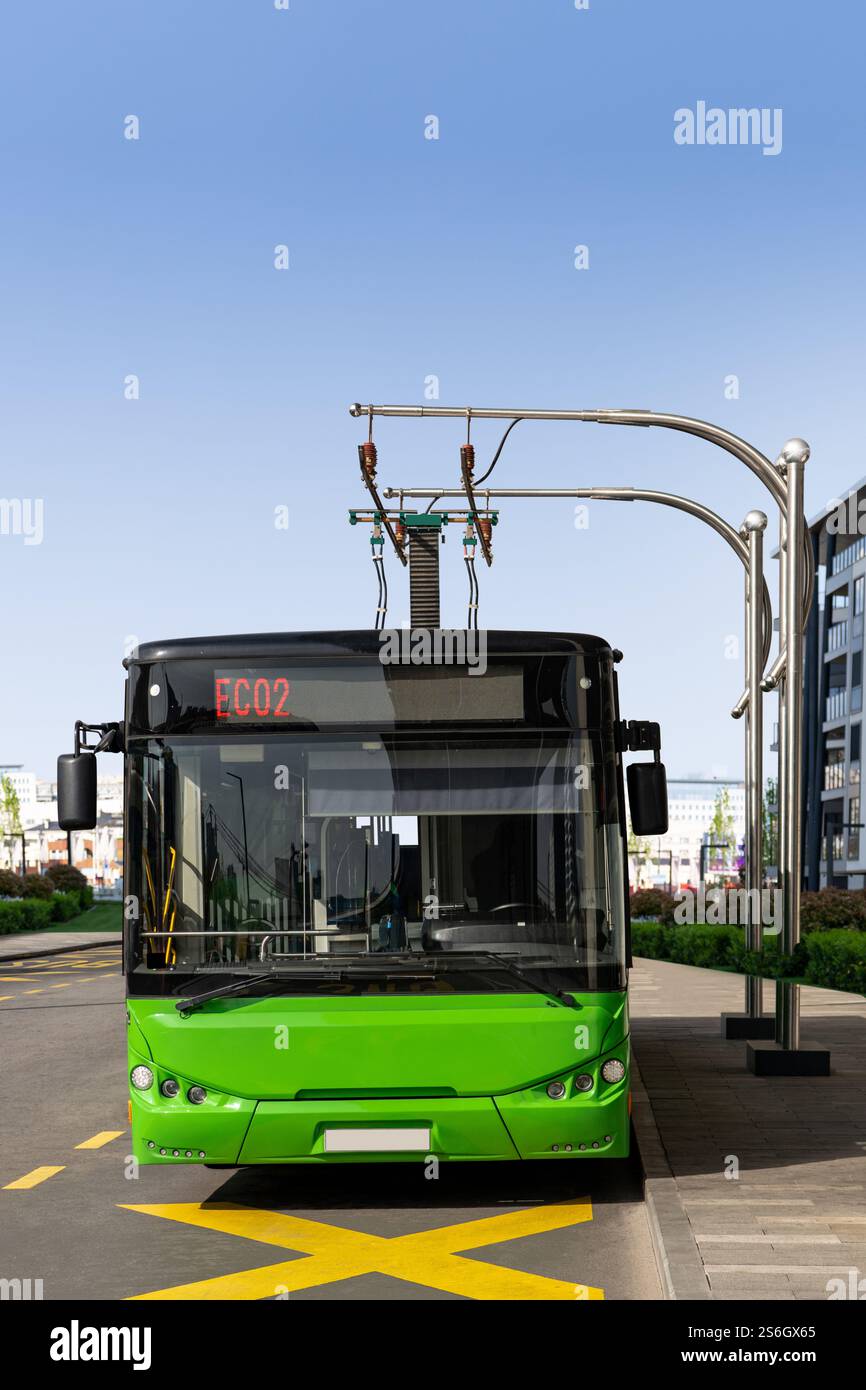 Electric bus at a stop is charged by pantograph Stock Photo - Alamy
