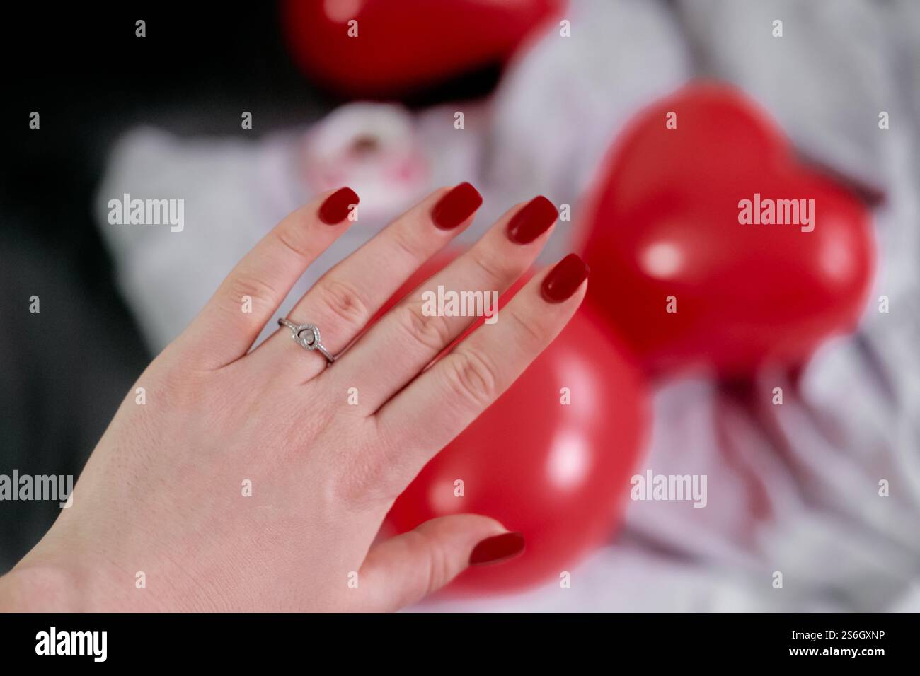 A woman's hand with a ring on her middle finger, her beloved proposed ...