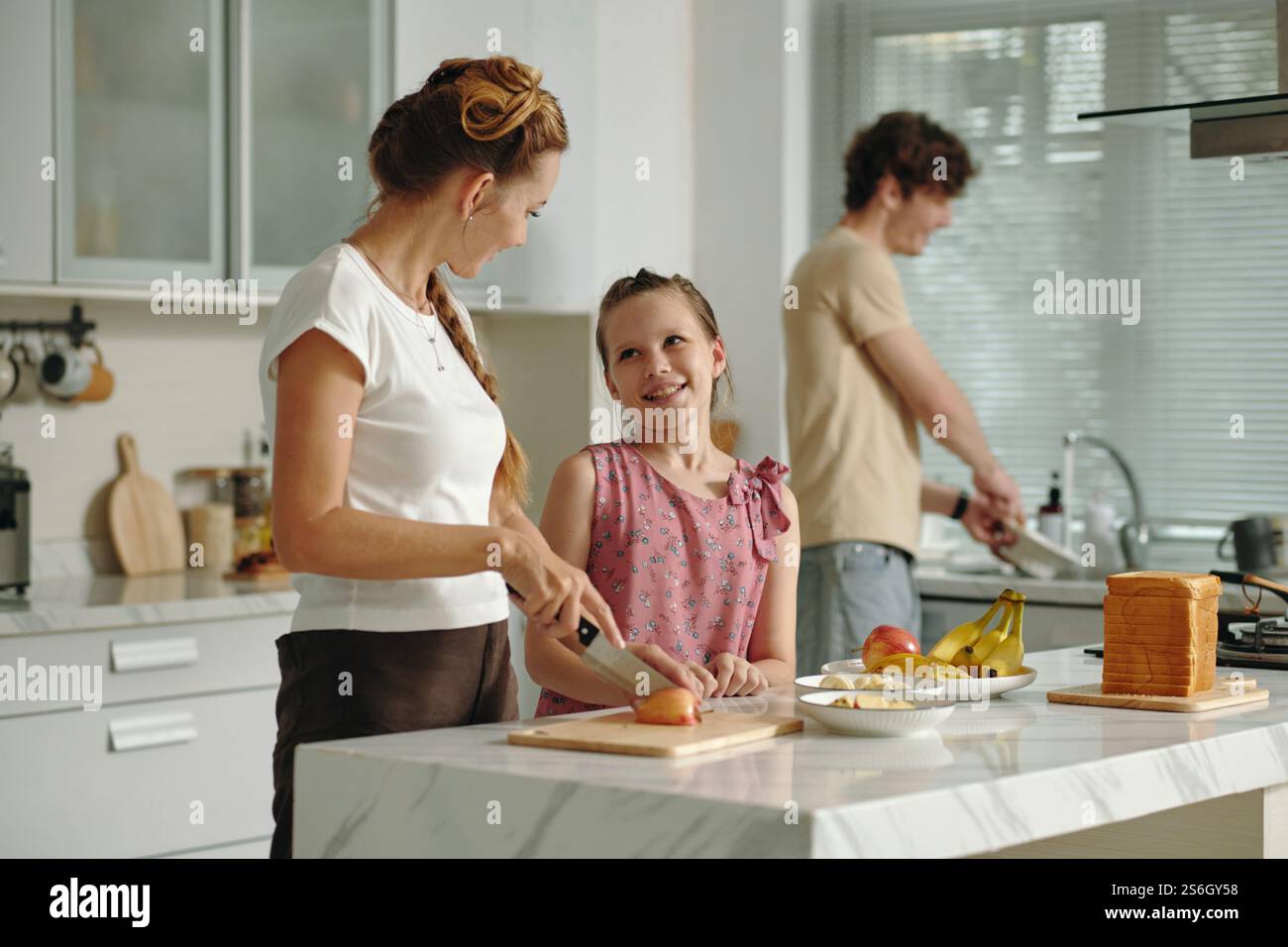 Family Cooking Together In The Kitchen Stock Photo - Alamy