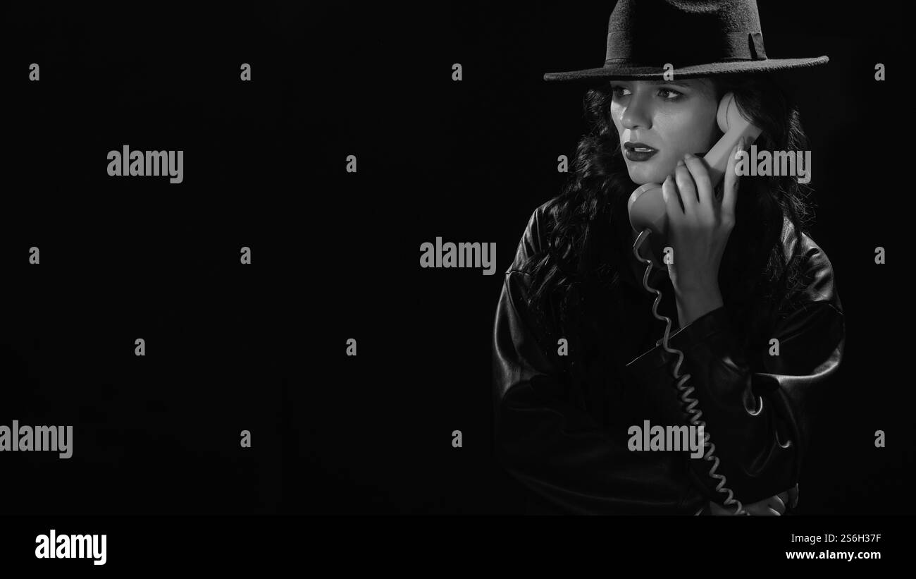 Dark noir portrait of a female detective holding a retro telephone ...
