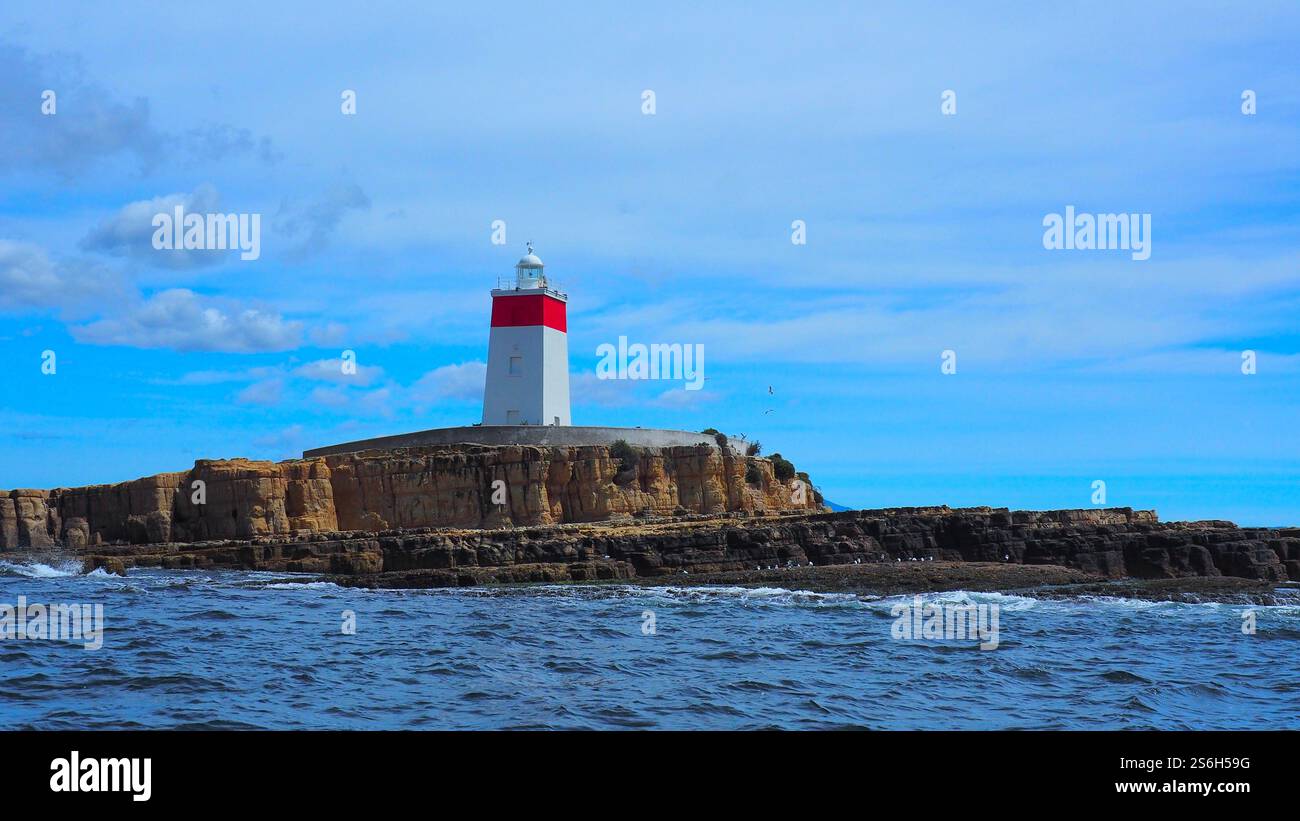 Hobart's Iron Pot lighthouse, freshly painted and seen from a harbour ...