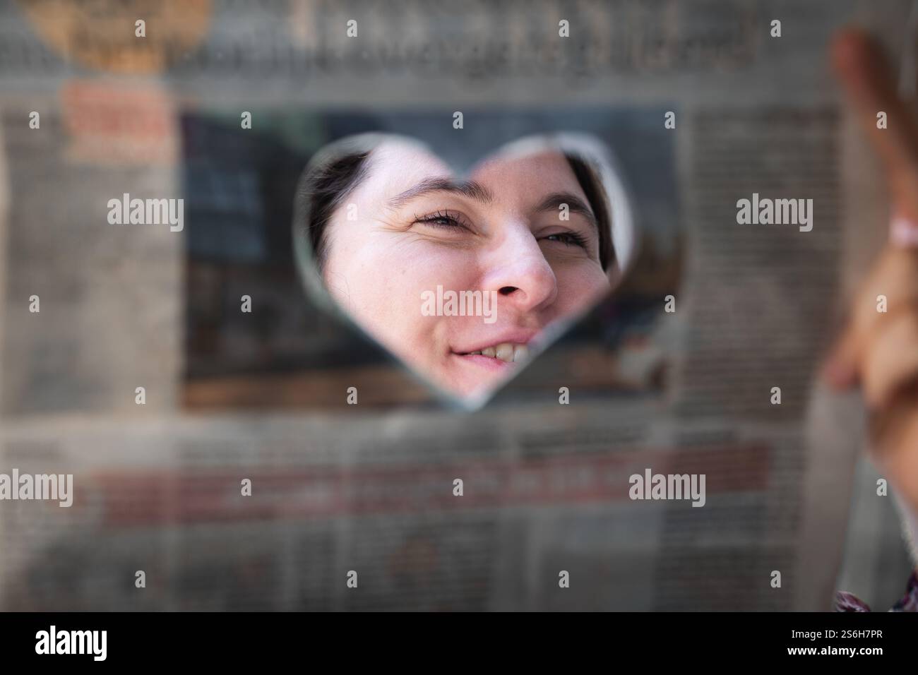 Heart cut out of a newspaper Stock Photo - Alamy