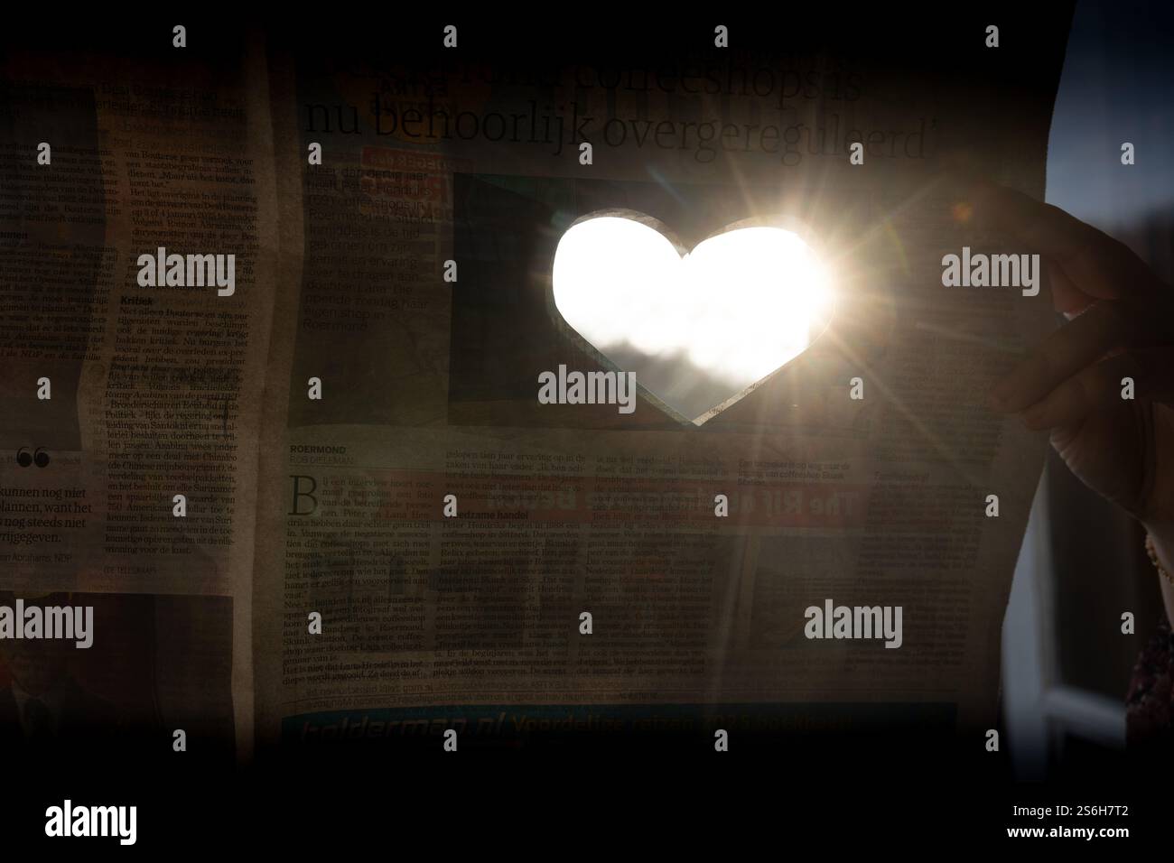 Heart cut out of a newspaper Stock Photo - Alamy