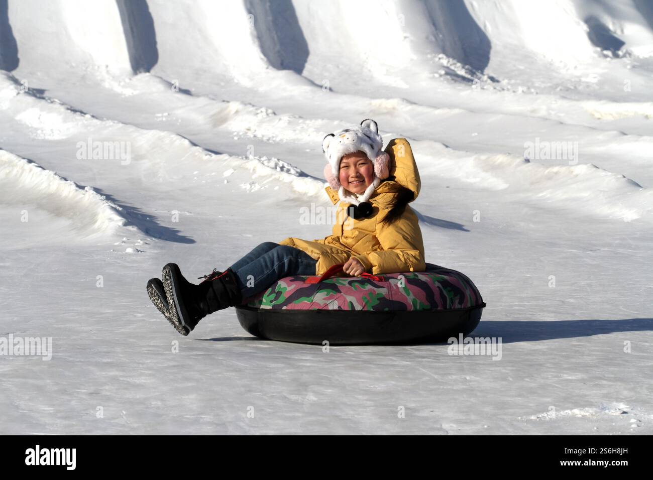 Tourists play at a snow park in Shenyang City, northeast China's ...