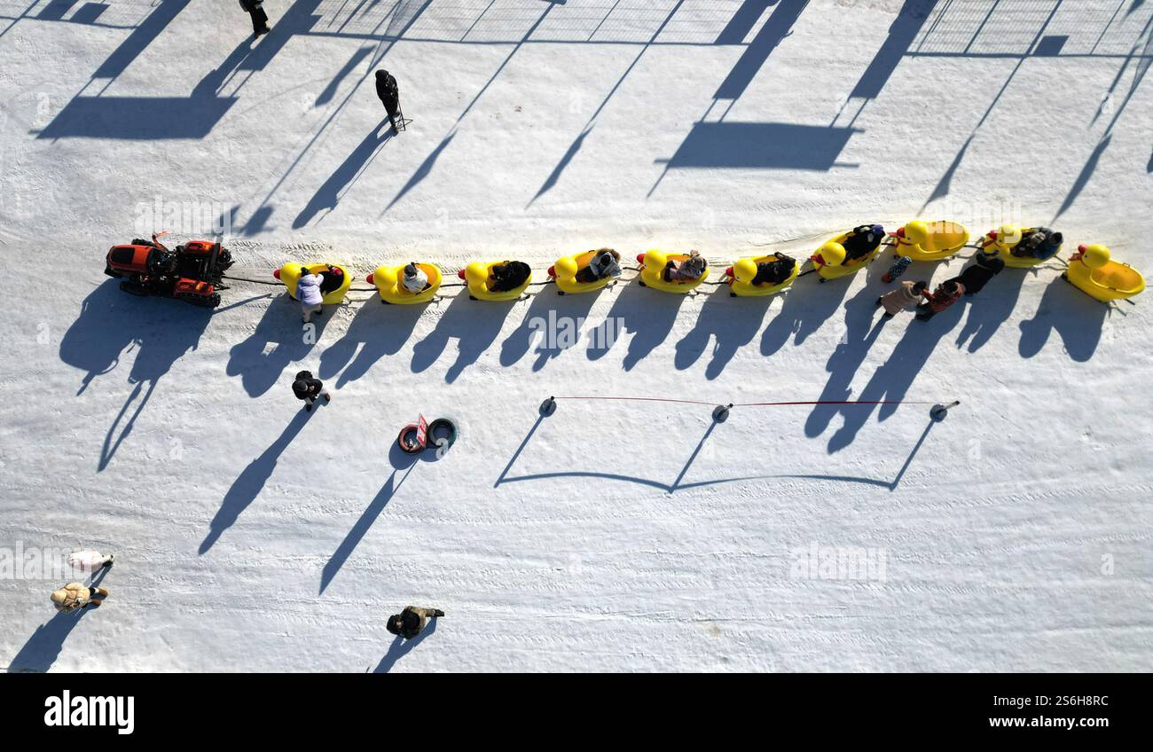 Tourists play at a snow park in Shenyang City, northeast China's ...