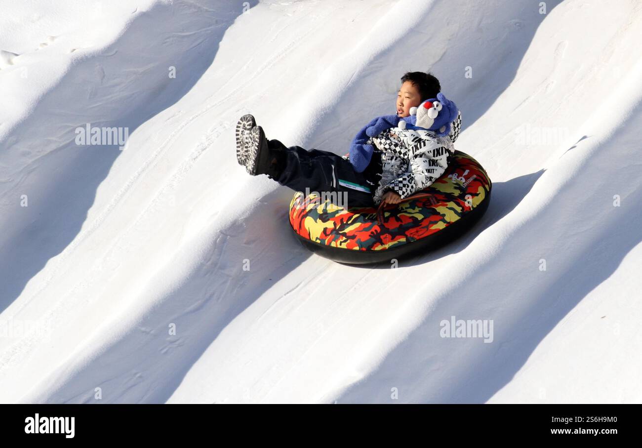 Tourists play at a snow park in Shenyang City, northeast China's ...