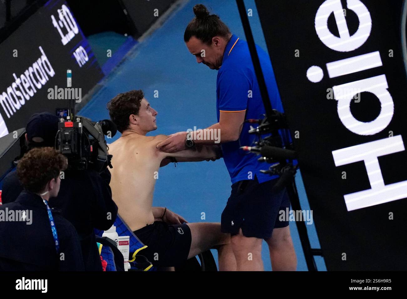 Ugo Humbert of France receives treatment from a trainer during his ...