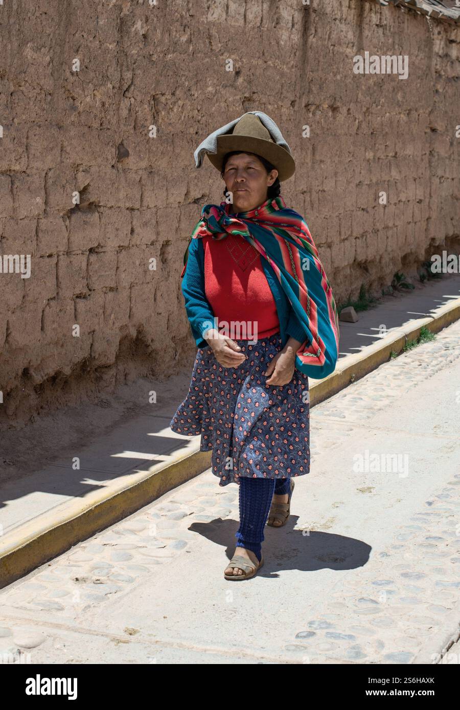 08/11/2019 - Maras, Peru: Indigenous woman walking down a rural street ...