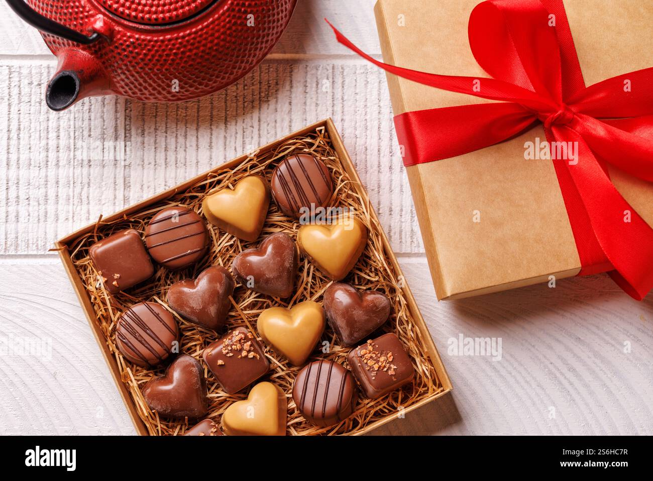 Valentines day box of rich chocolates, set against a wooden backdrop ...