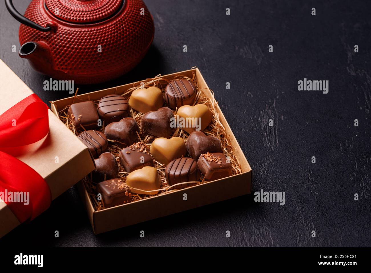 A romantic Valentines Day setup featuring a box of assorted chocolates ...