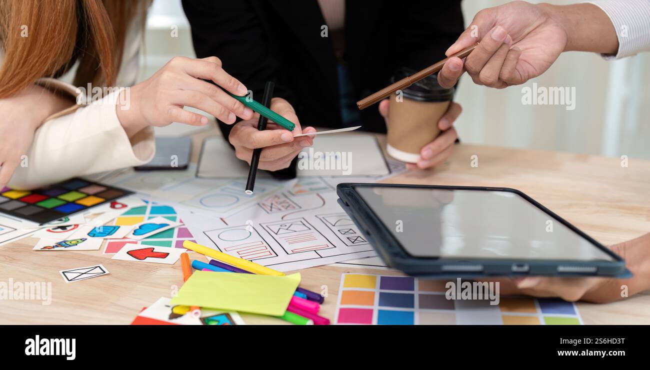 Collaborative Ux Ui Team Examining Design Notes And Sketches While Engaging In A Creative